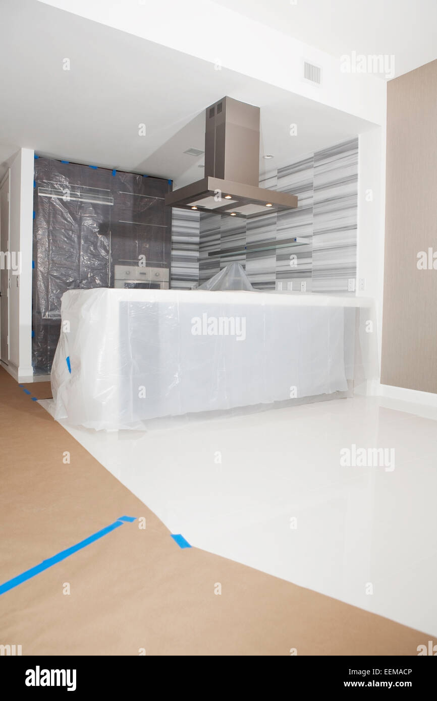 Protective plastic and paper tarps in kitchen under renovation Stock ...