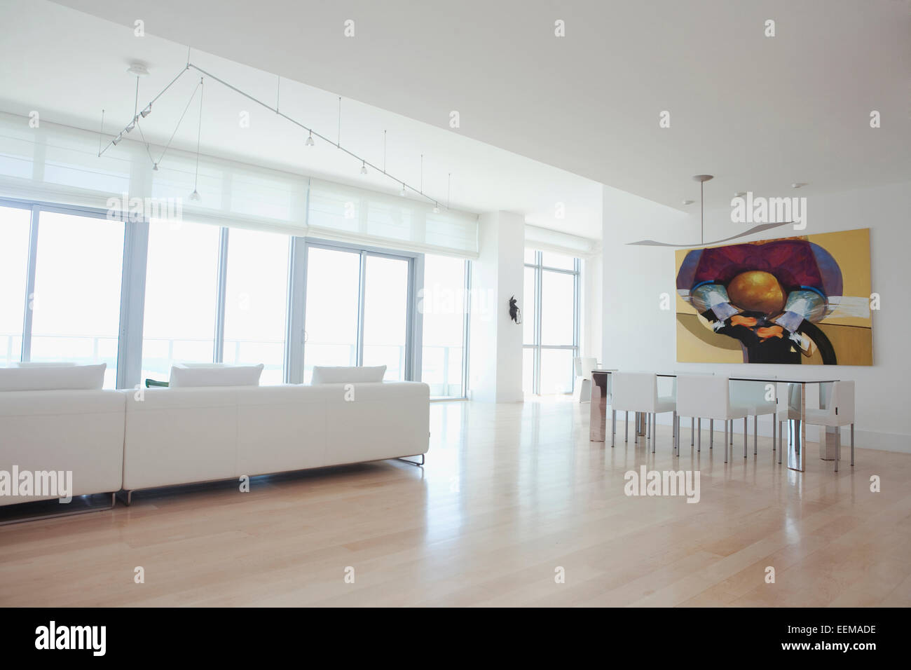 Sofa and dining table in open living space of apartment Stock Photo - Alamy