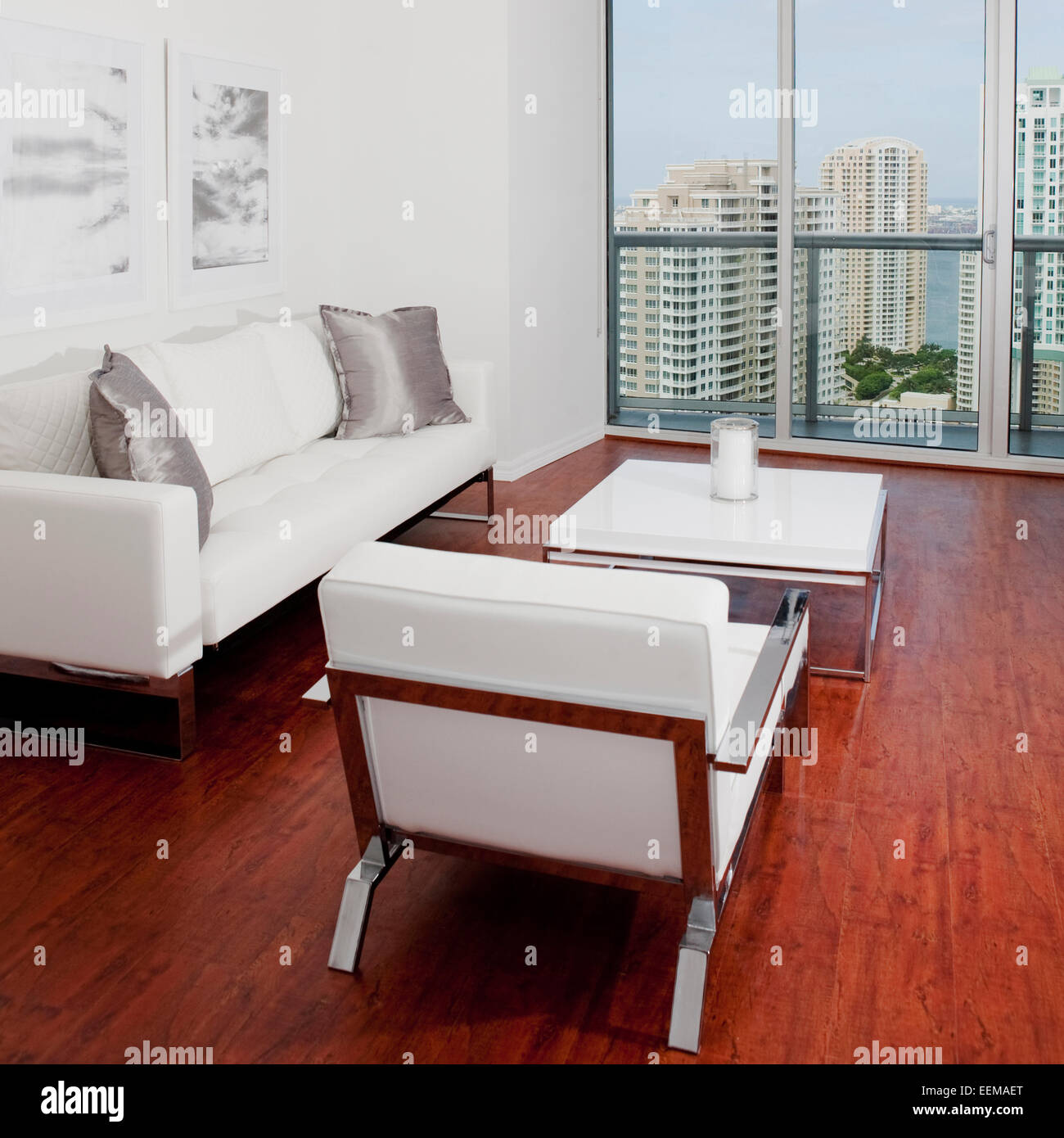 Sofas, coffee table and window overlooking high rise buildings in ...