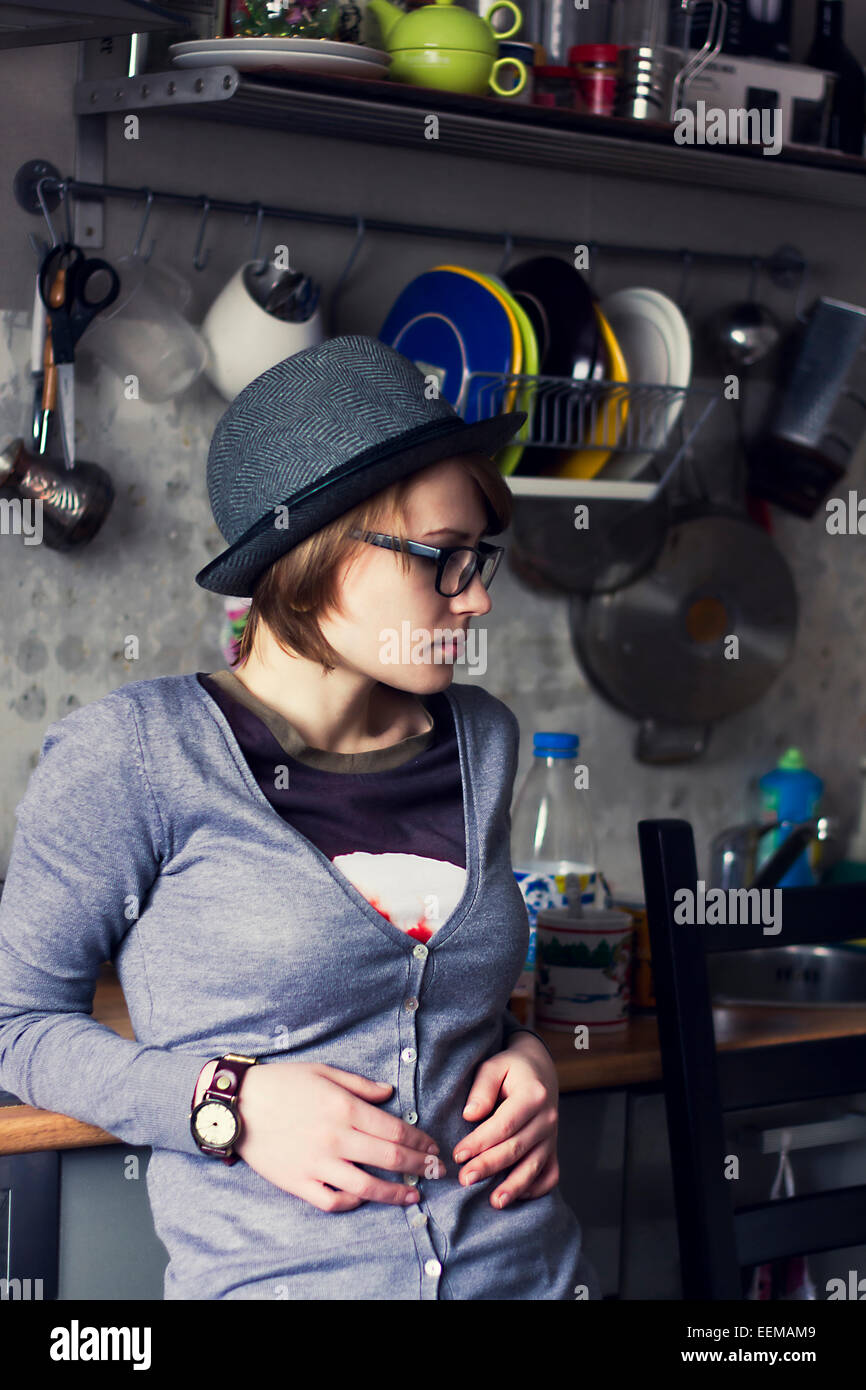 Caucasian woman leaning on kitchen counter Stock Photo - Alamy