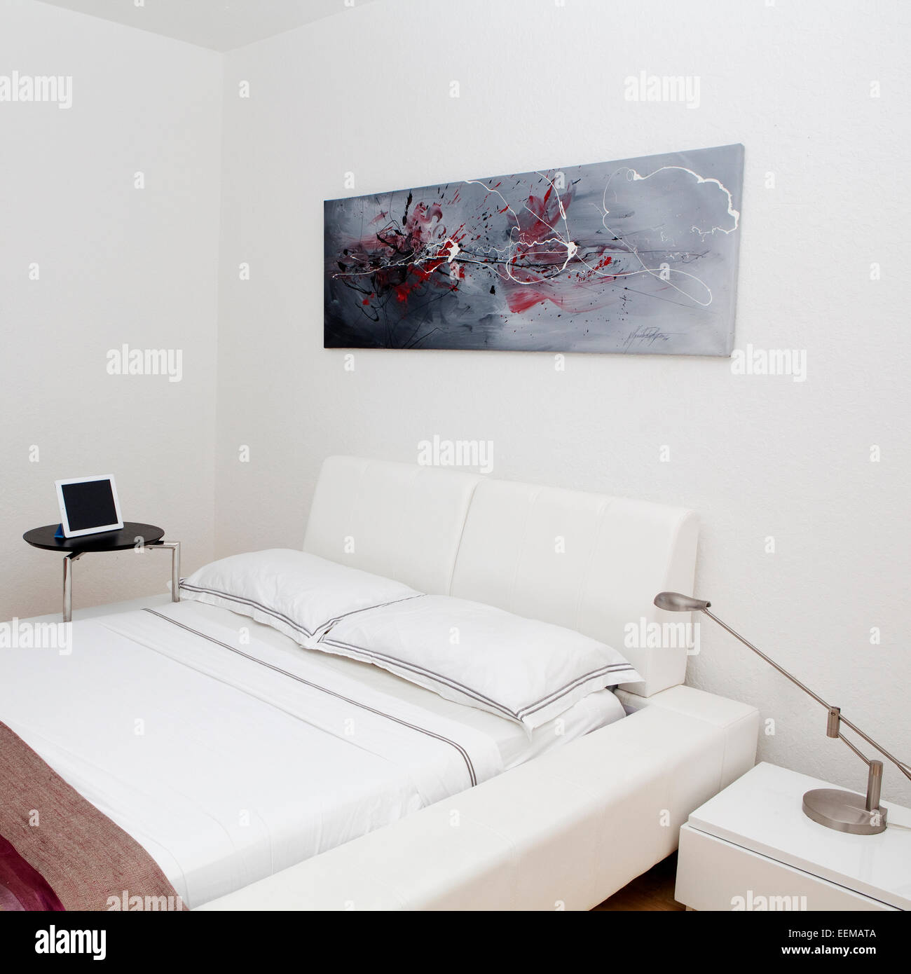 Night table, wall art and bed in modern bedroom Stock Photo - Alamy