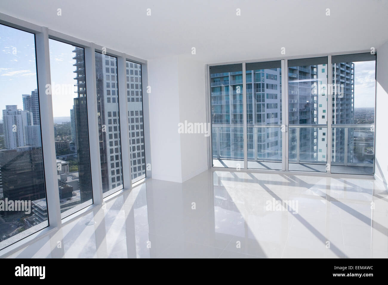 Windows of empty modern apartment overlooking cityscape Stock Photo - Alamy