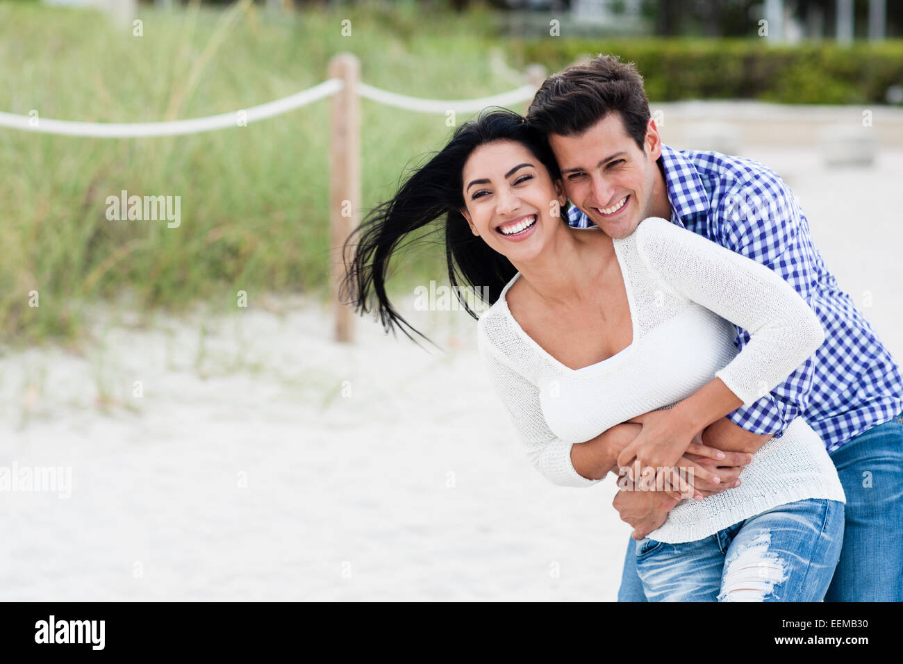 Hispanic couple hugging outdoors Stock Photo - Alamy