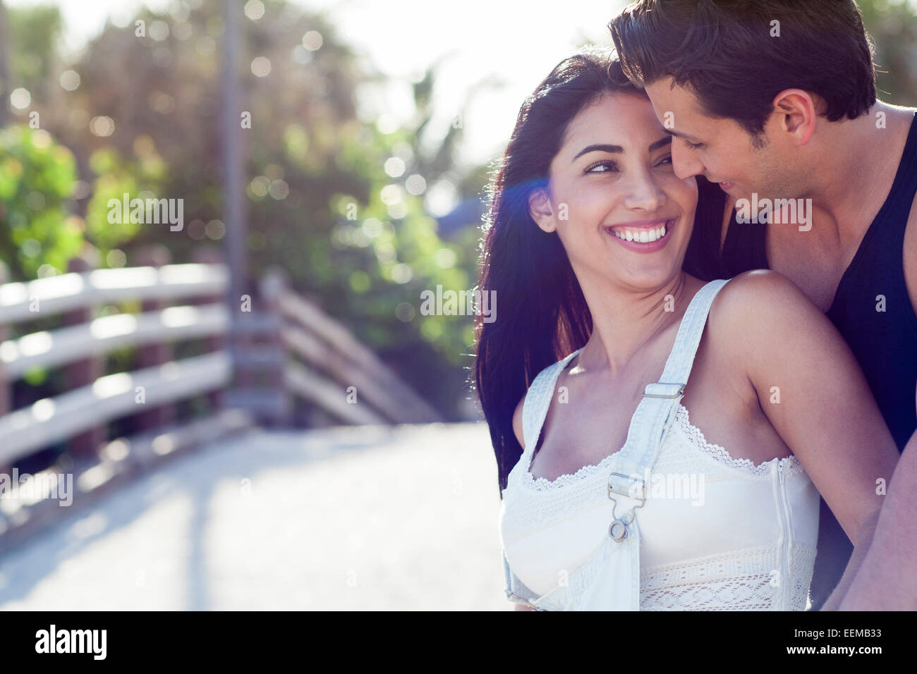 Hispanic couple hugging outdoors Stock Photo - Alamy