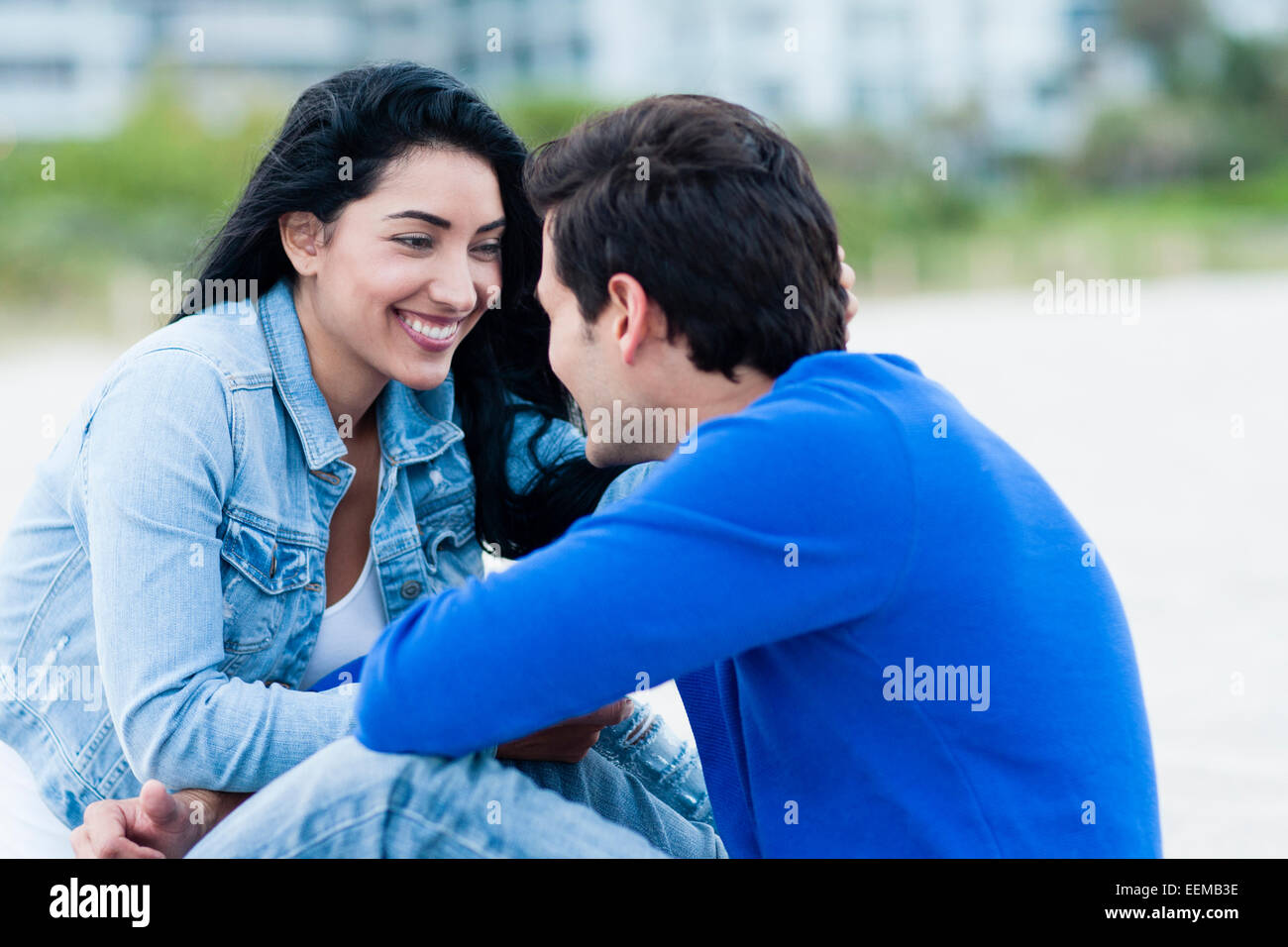 Young couple chatting on beach hi-res stock photography and images - Alamy