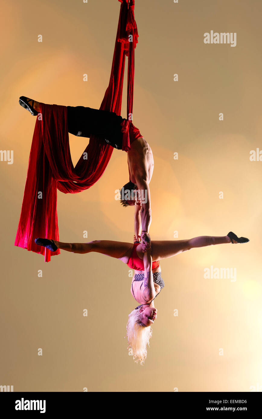 Caucasian acrobats performing with silk ropes Stock Photo - Alamy