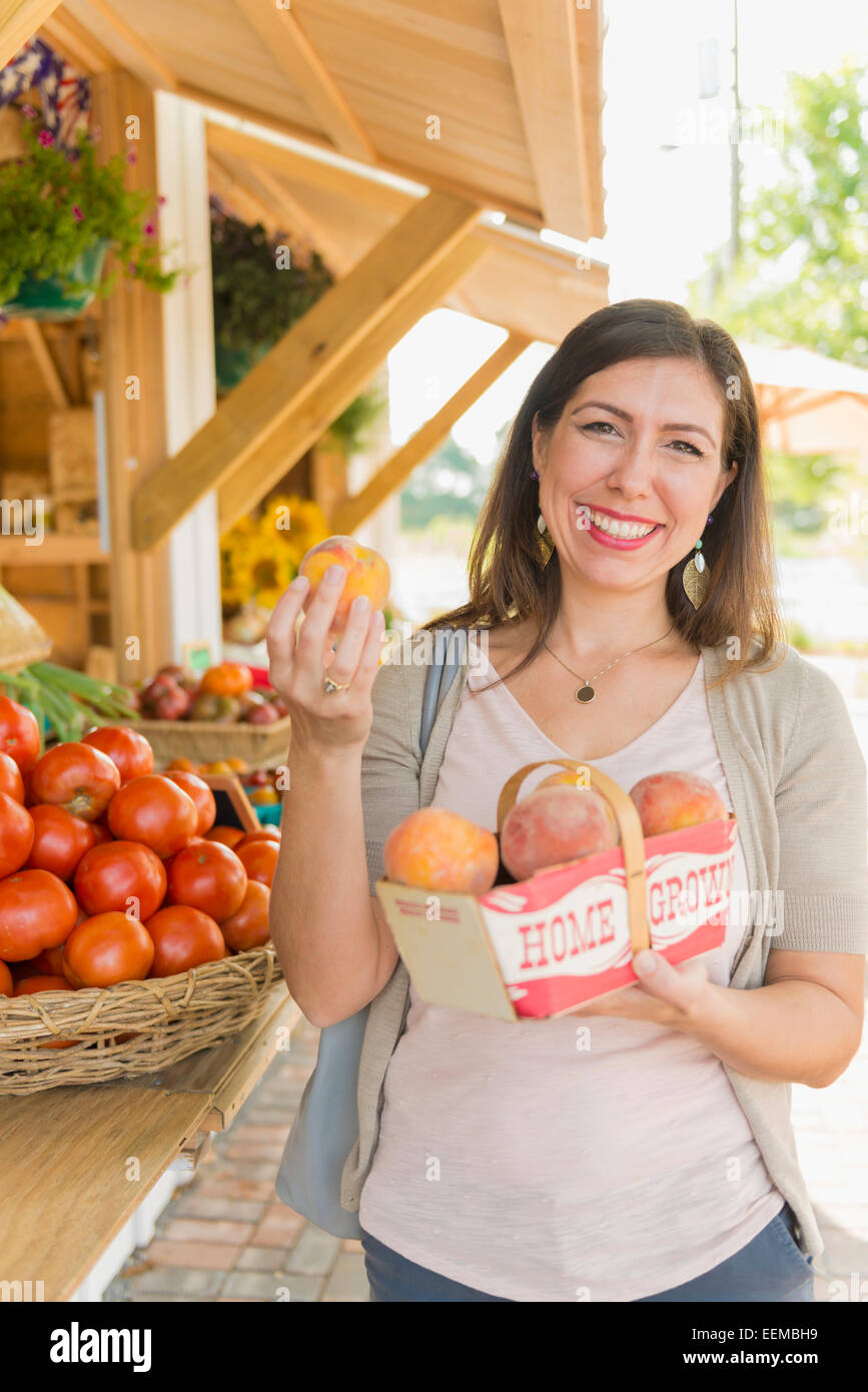 Woman produce stand looking at camera hi-res stock photography and ...