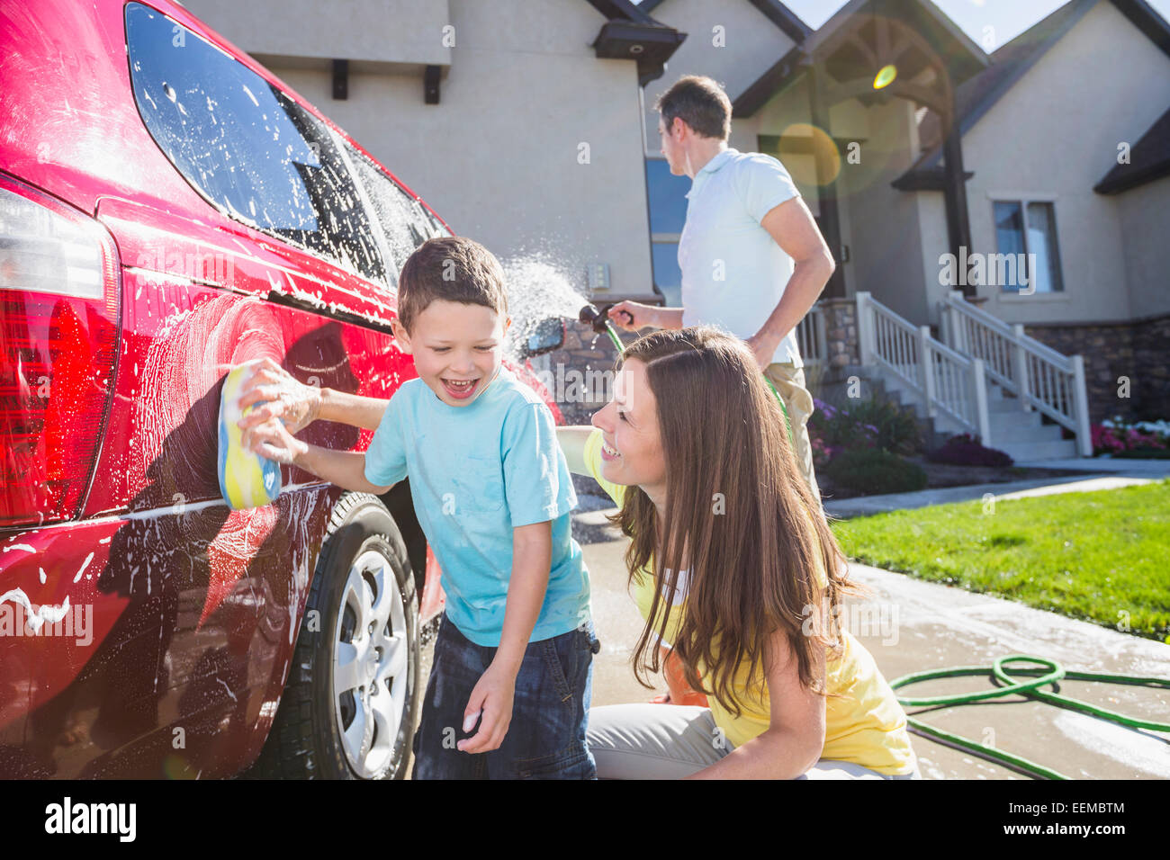 Child and women washing car together hi-res stock photography and ...