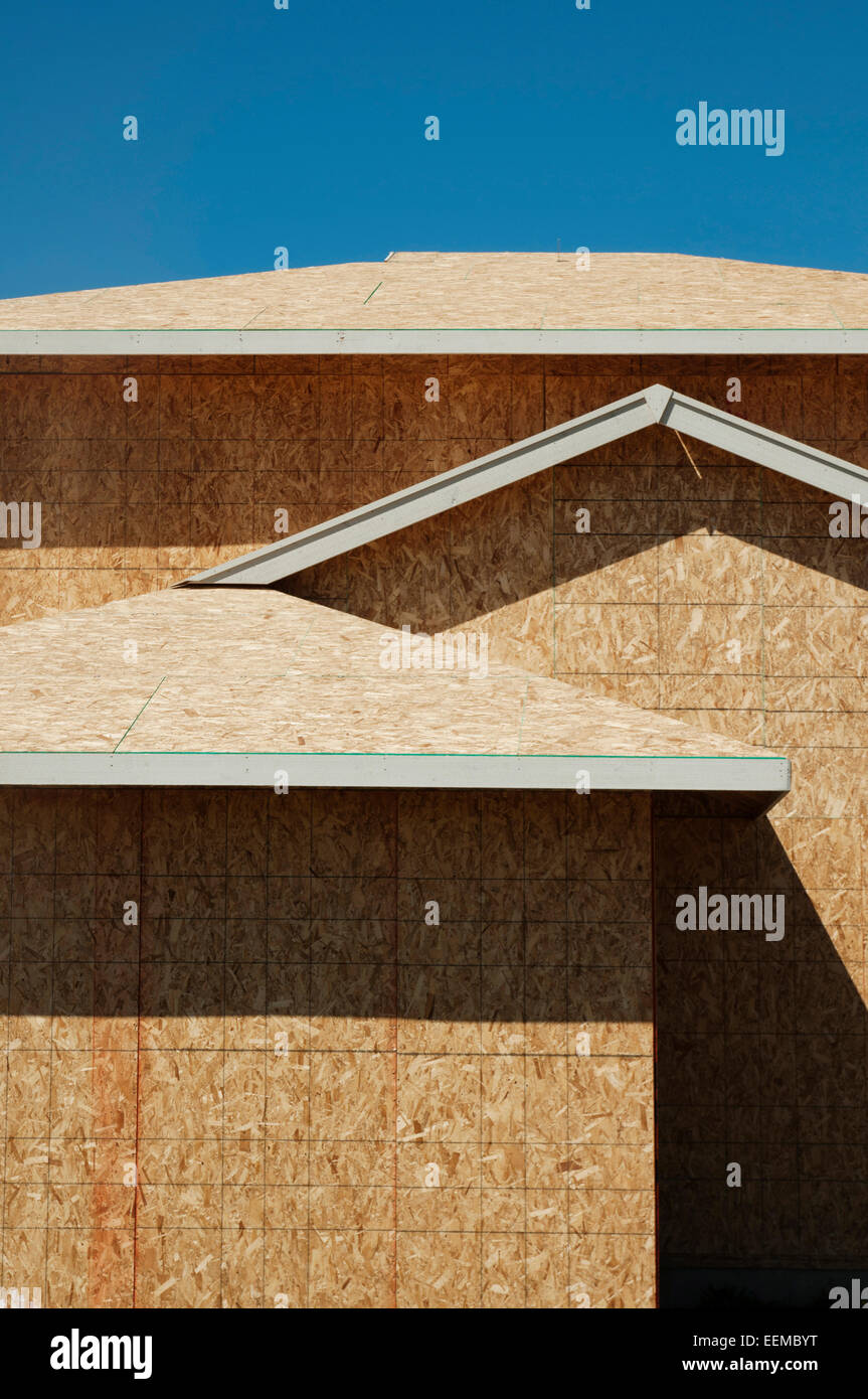 Low angle view of chip board walls of house under construction Stock ...