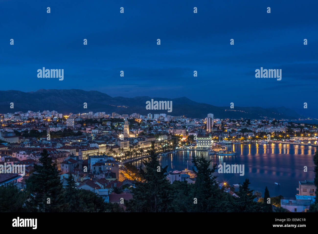 Aerial view of illuminated dock and cityscape of coastal town, Split ...