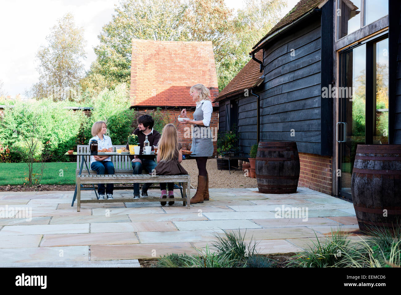 Caucasian family eating breakfast in backyard Stock Photo - Alamy