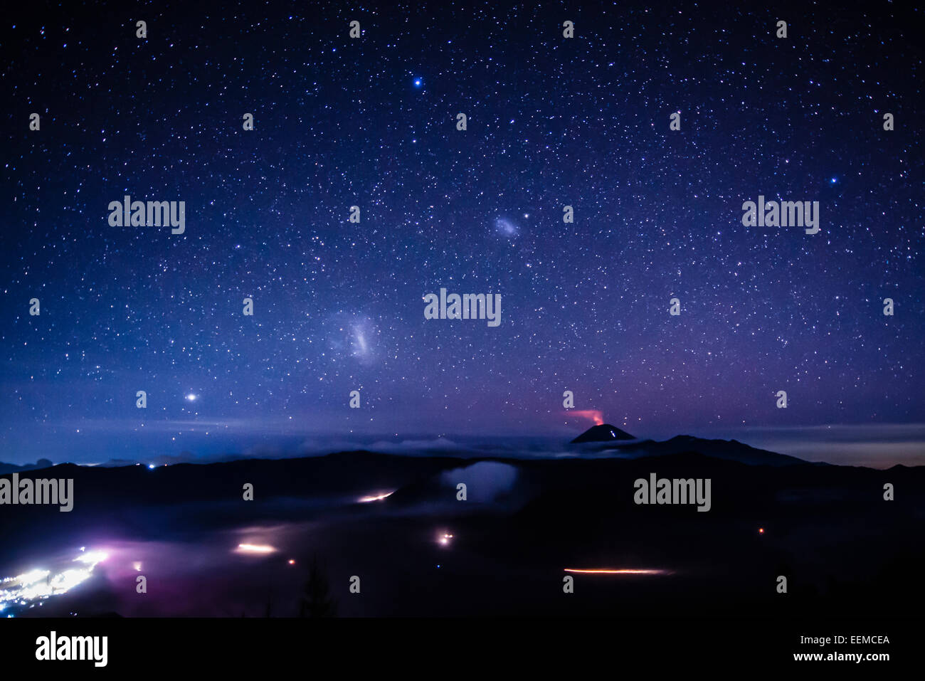 Starry night sky over active volcano Stock Photo - Alamy