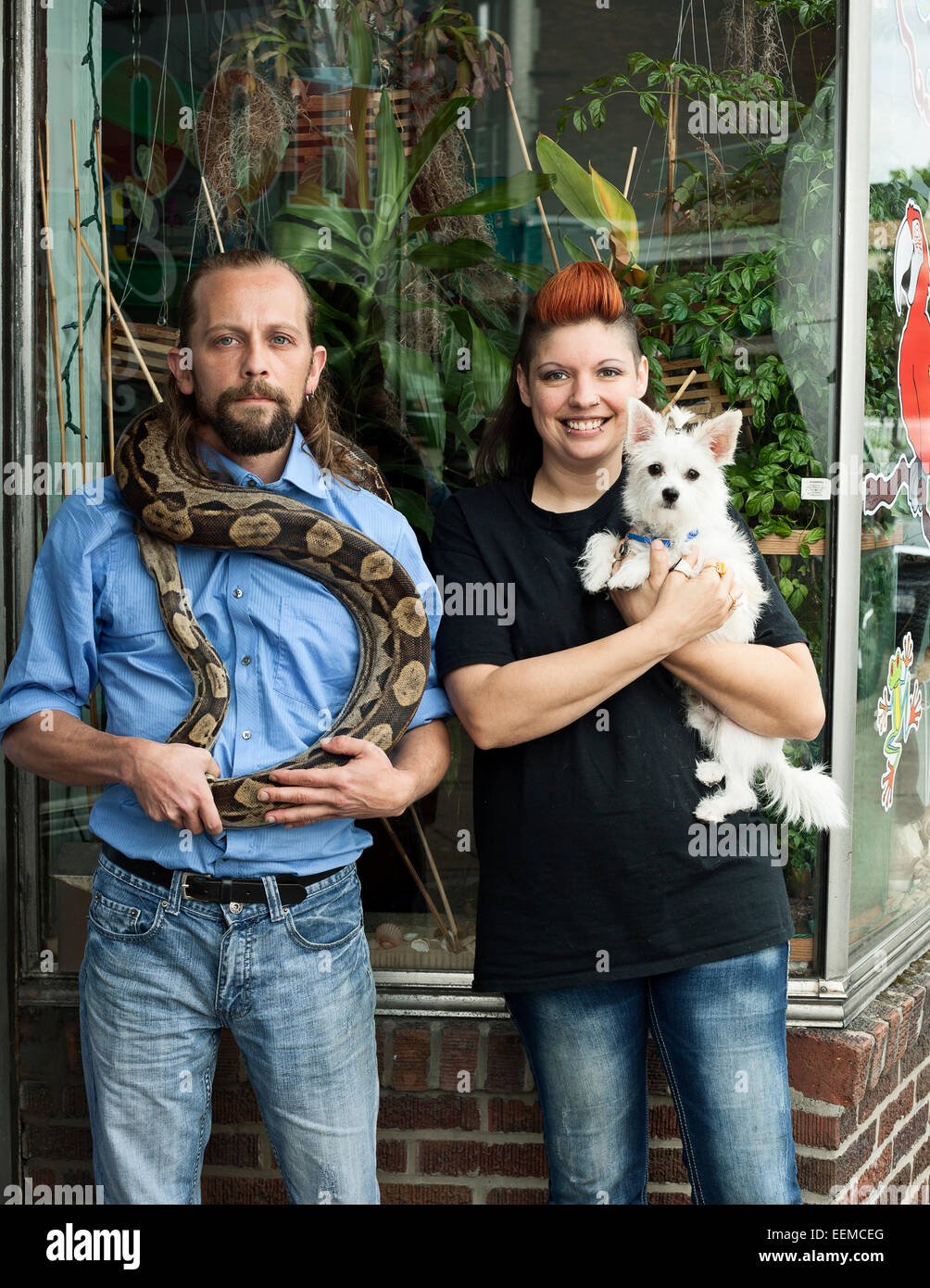 Caucasian couple holding pets outdoors Stock Photo - Alamy