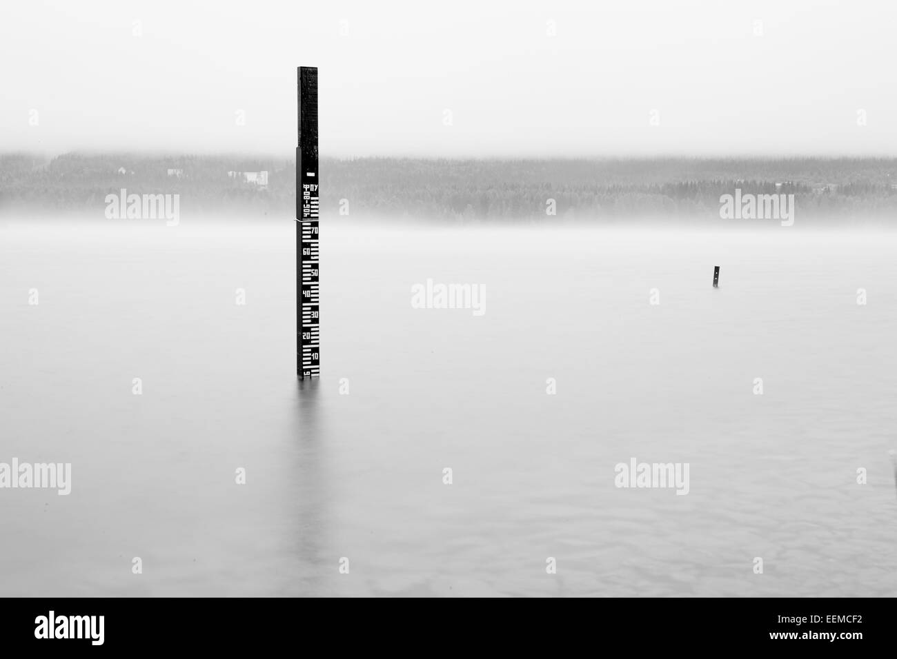 Wooden measuring post in water Stock Photo - Alamy