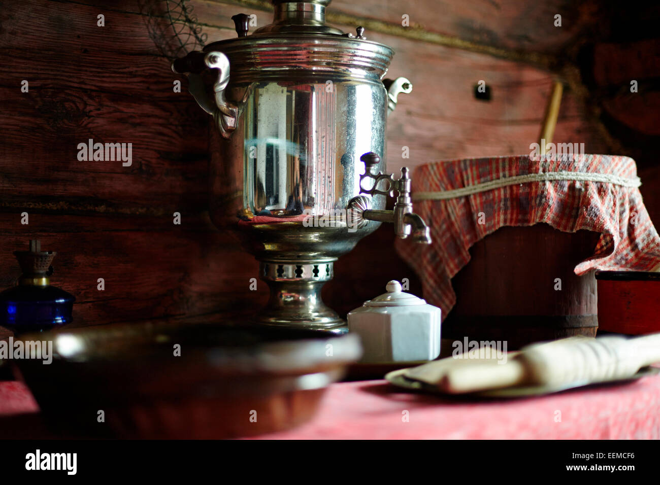 Tea dispenser and plates on table Stock Photo - Alamy