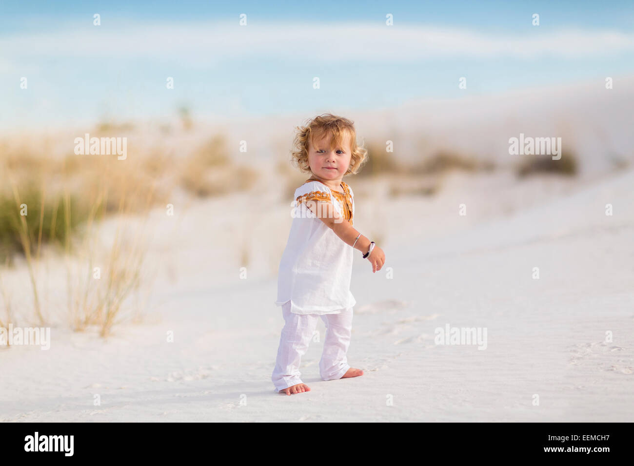 Caucasian boy walking on sand dune Stock Photo - Alamy