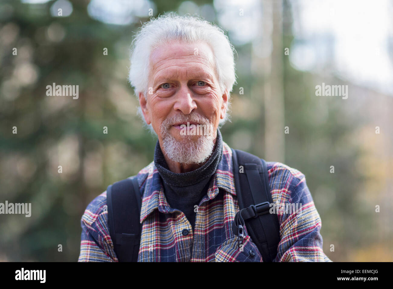 Caucasian hiker smiling in forest Stock Photo - Alamy