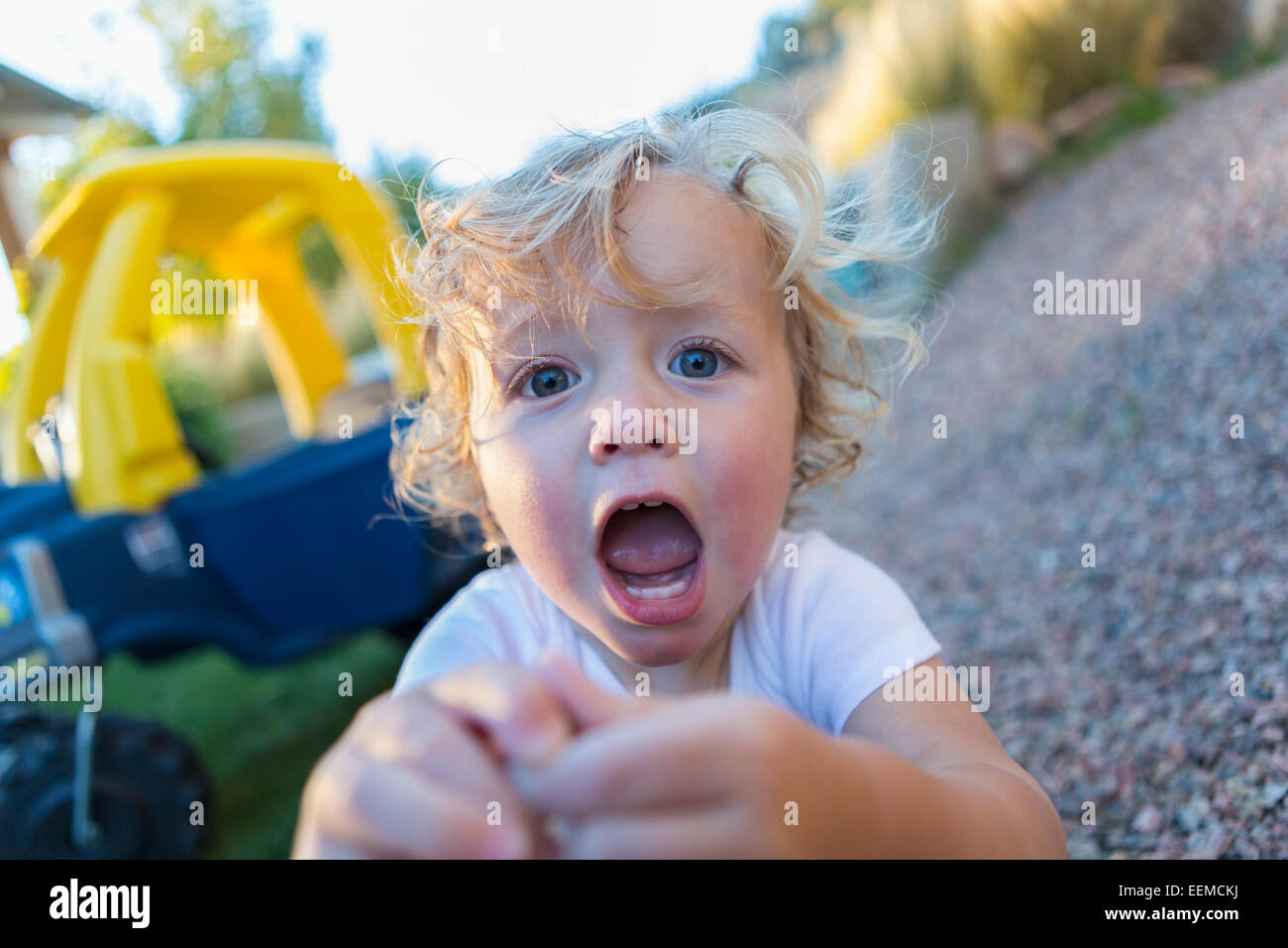 Caucasian boy shouting in backyard Stock Photo - Alamy