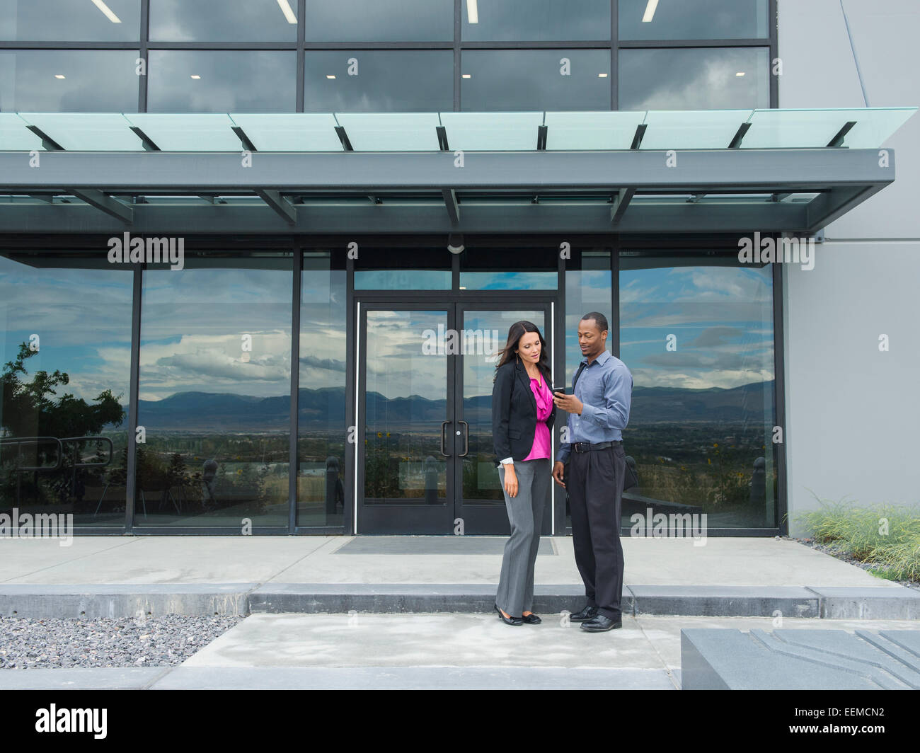 Business people talking outside office building Stock Photo - Alamy