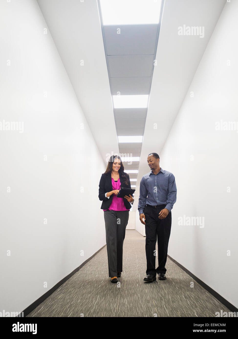 Business people talking in office corridor Stock Photo - Alamy