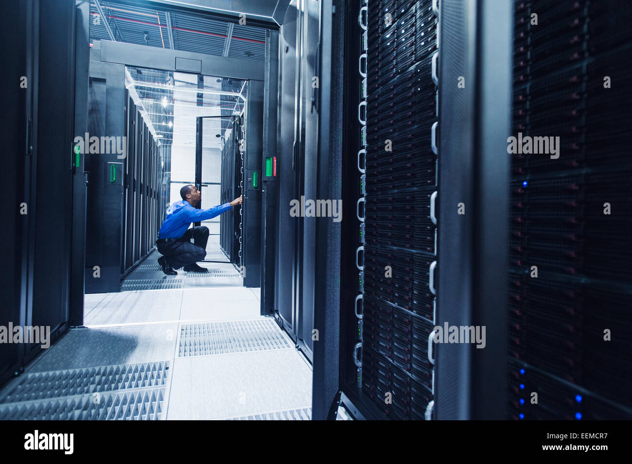 Black businessman working in server room Stock Photo - Alamy
