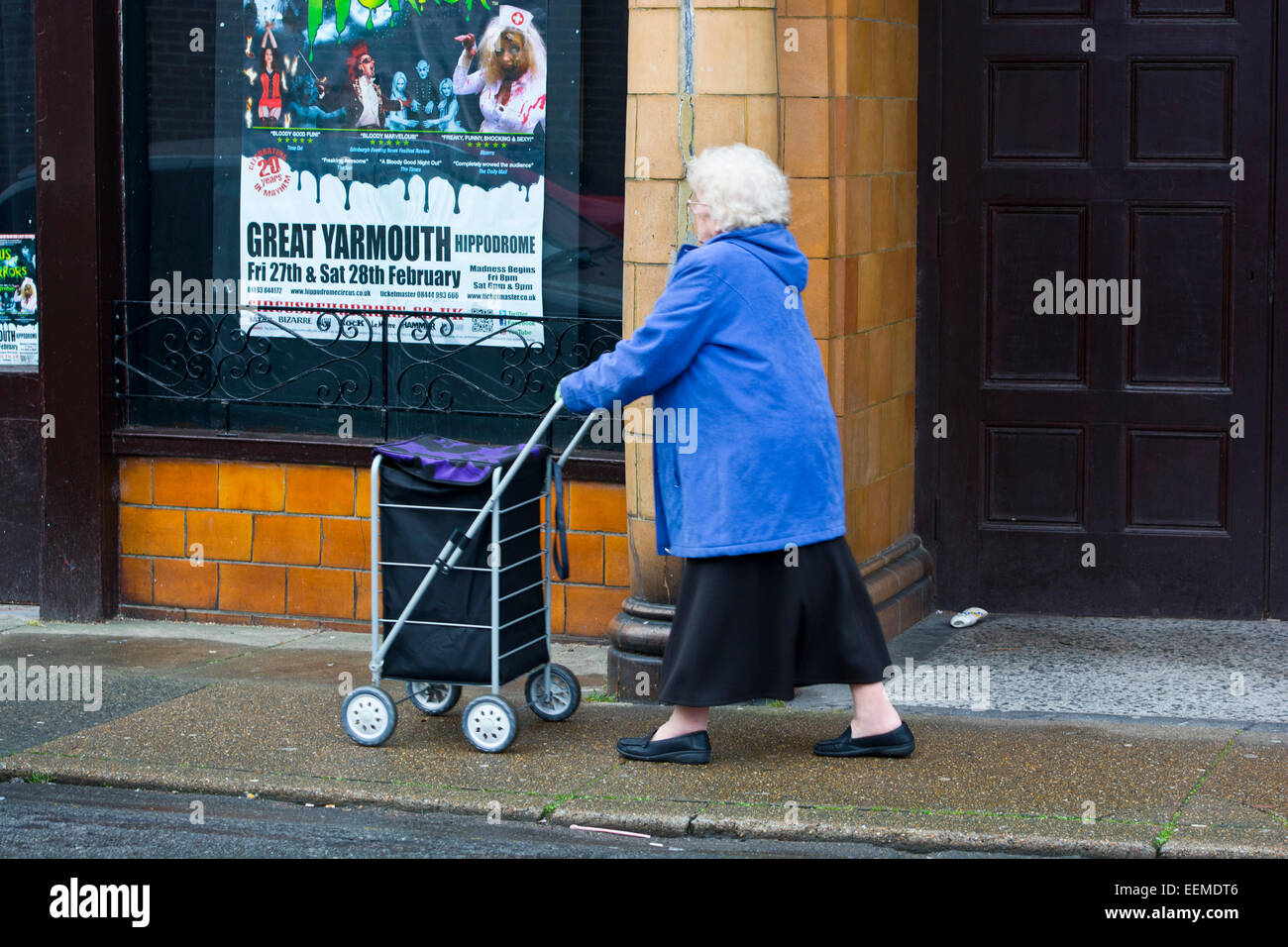 pensioner senior female old woman pushing shopping basket trolley ...