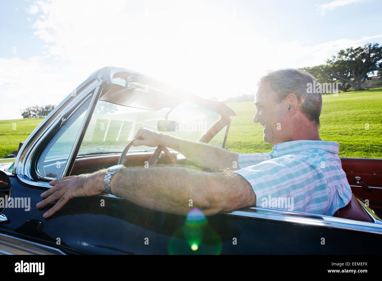 Caucasian man driving classic convertible Stock Photo - Alamy