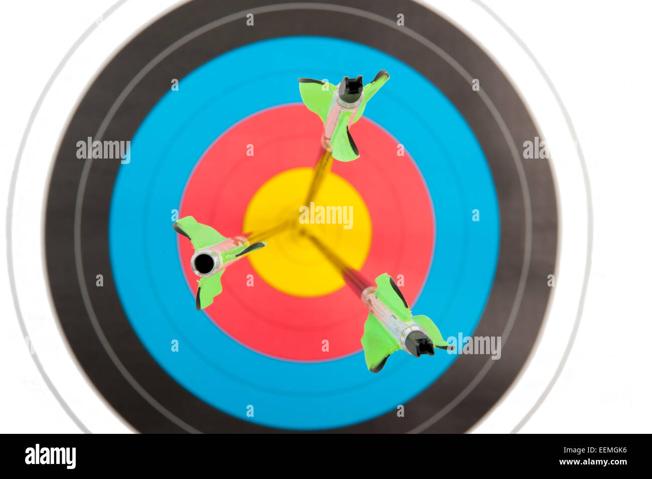 Three arrows hitting the bull's eye of an archery target in short dept ...