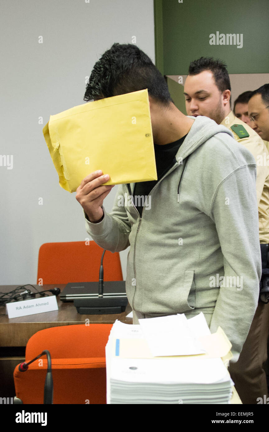 The defendant Harun P. (C) hides his face behind an envelope before the ...