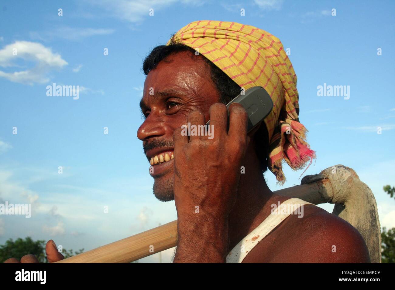 Bangladesh 10 January 2015. Farmer using cell phone Stock Photo - Alamy