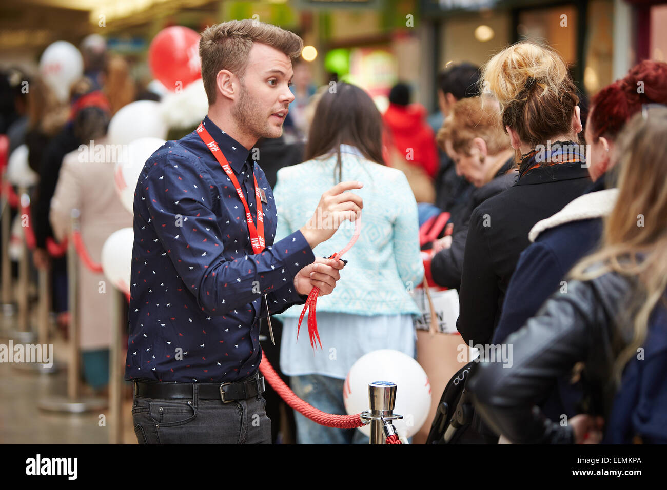 Staff member handing out goodie bags during the opening of a new H&M ...