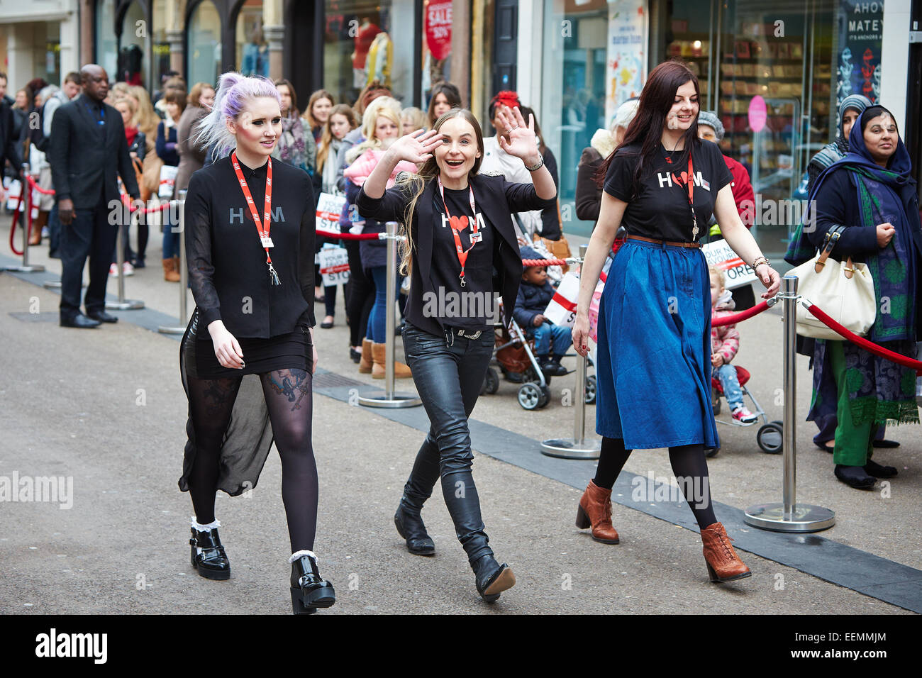Staff members entertain the queue during the opening of a new H&M store ...