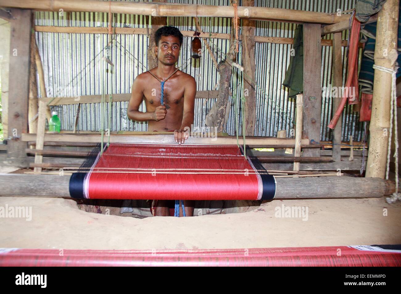Bangladesh 10 January 2015. A Tribal man weaving cloth on an old ...