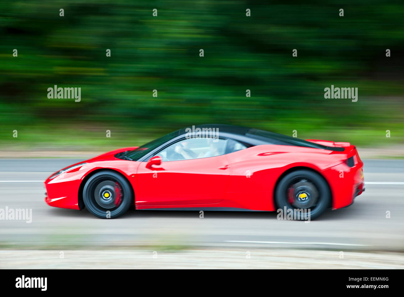 Red car driving on street hi-res stock photography and images - Alamy