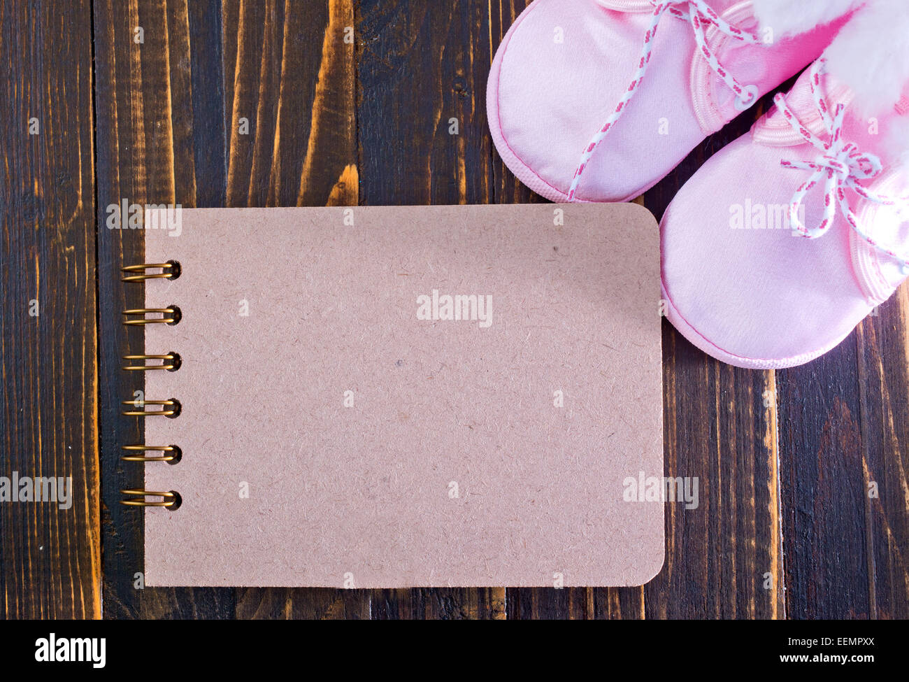 baby shoes and notepad for note on a table Stock Photo - Alamy