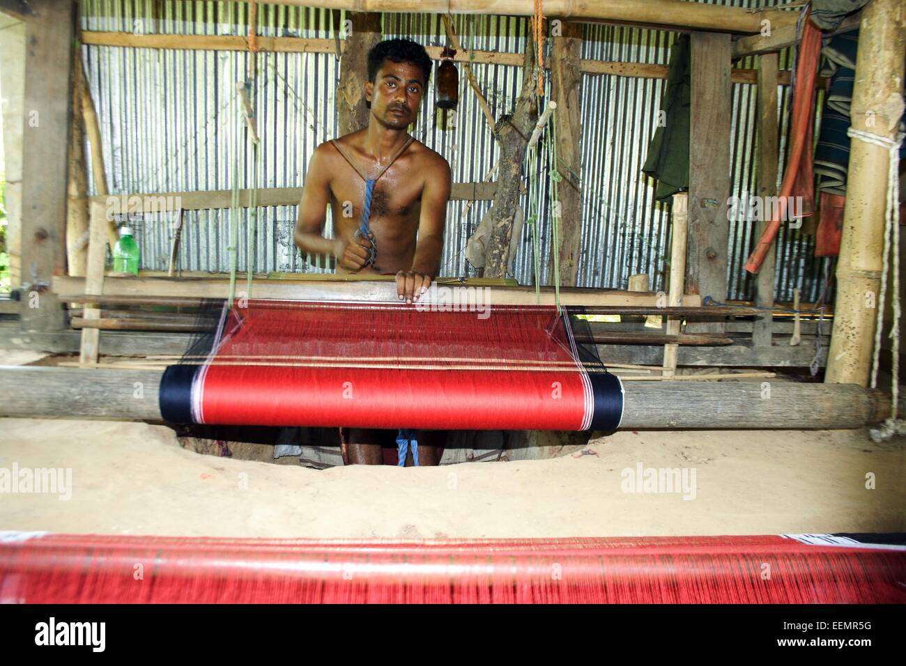 Bangladesh 10 January 2015. A Tribal man weaving cloth on an old ...