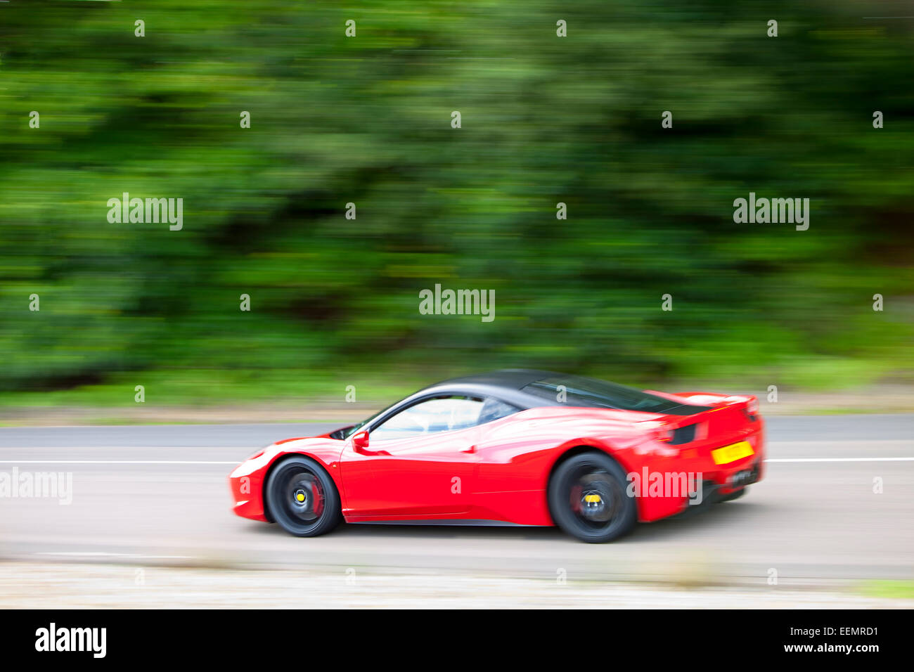 Red car driving fast hi-res stock photography and images - Alamy