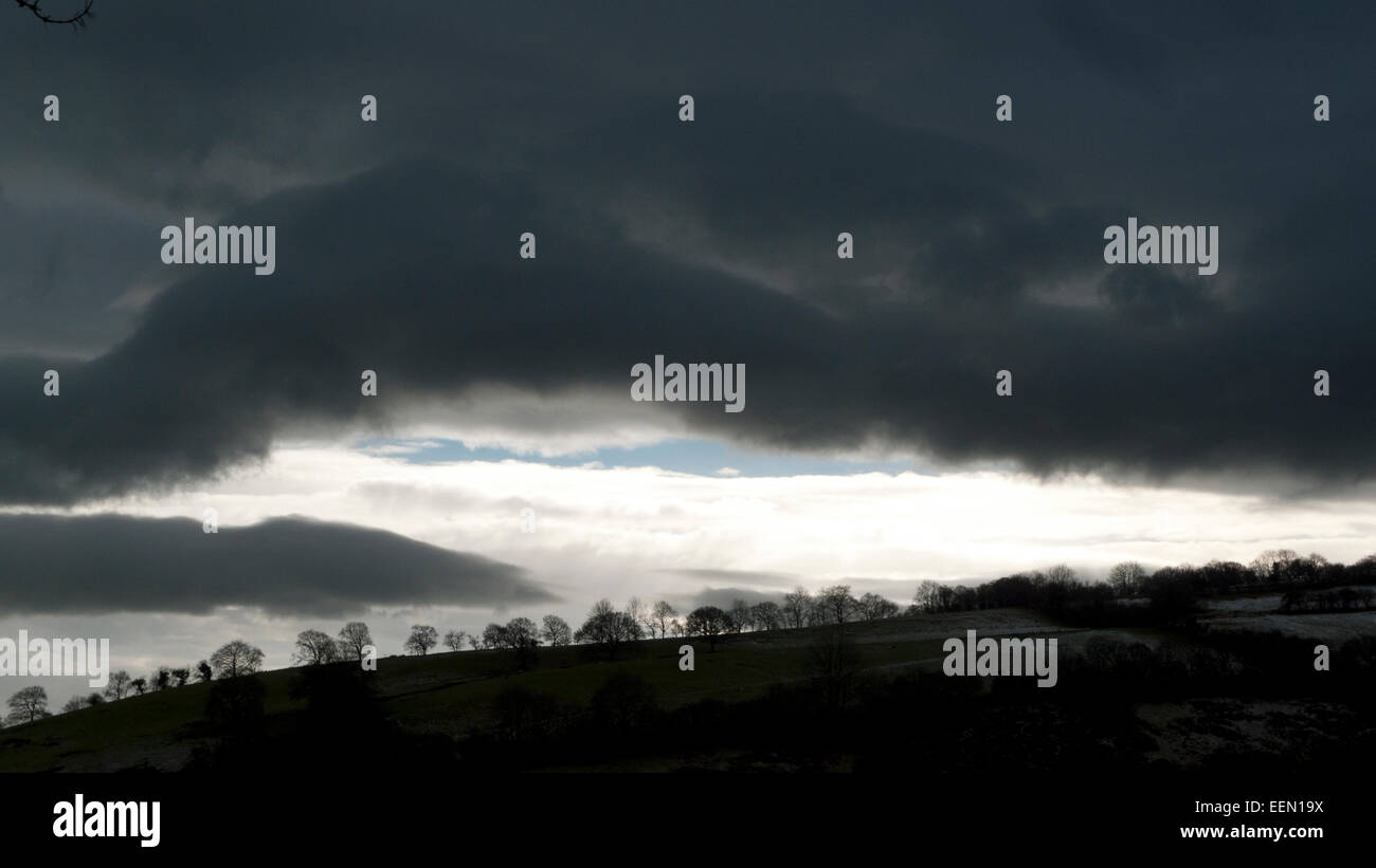 A dark sky with ominous black storm clouds portending rain, sleet or ...