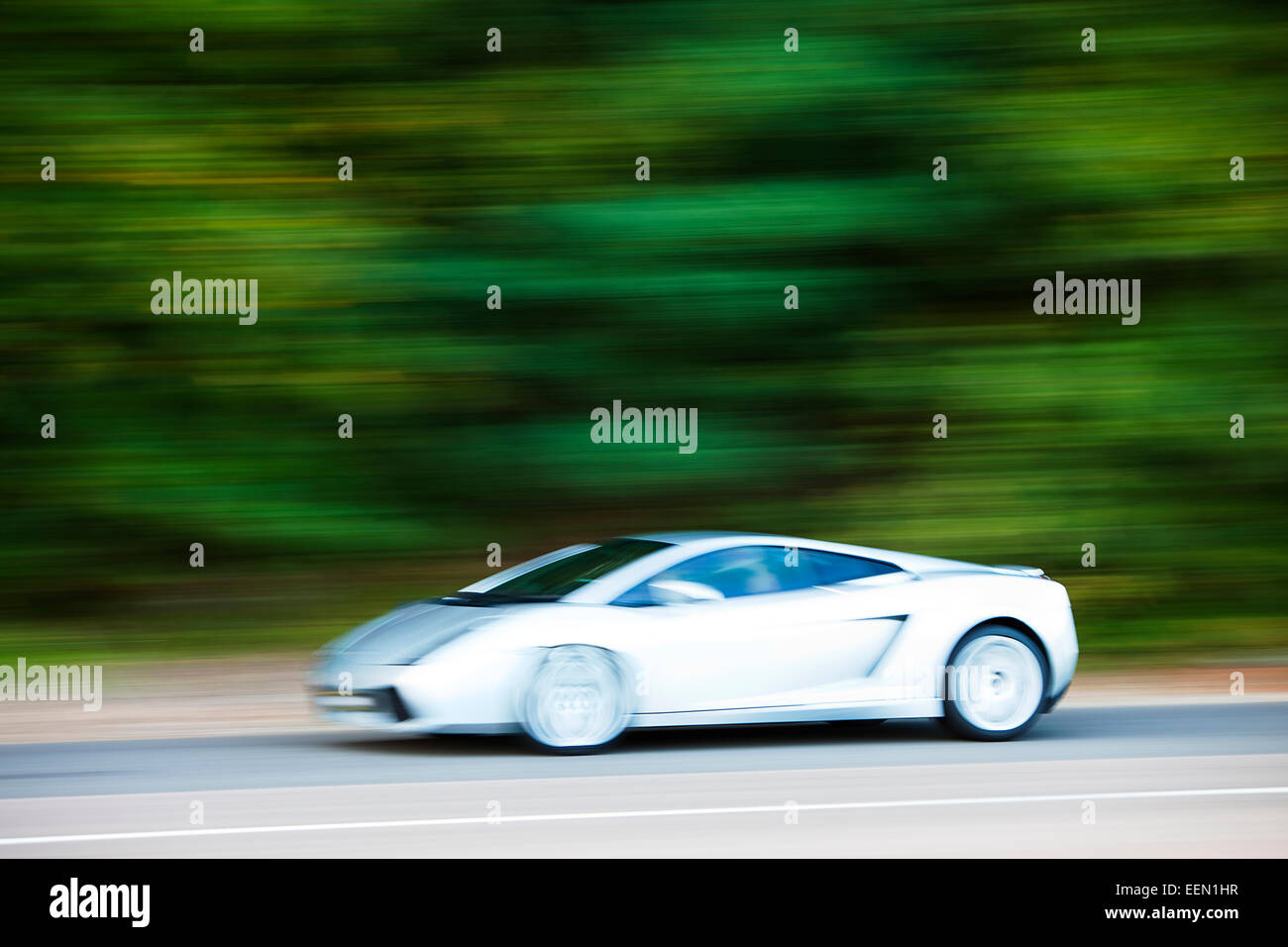 White car driving fast on country road Stock Photo - Alamy