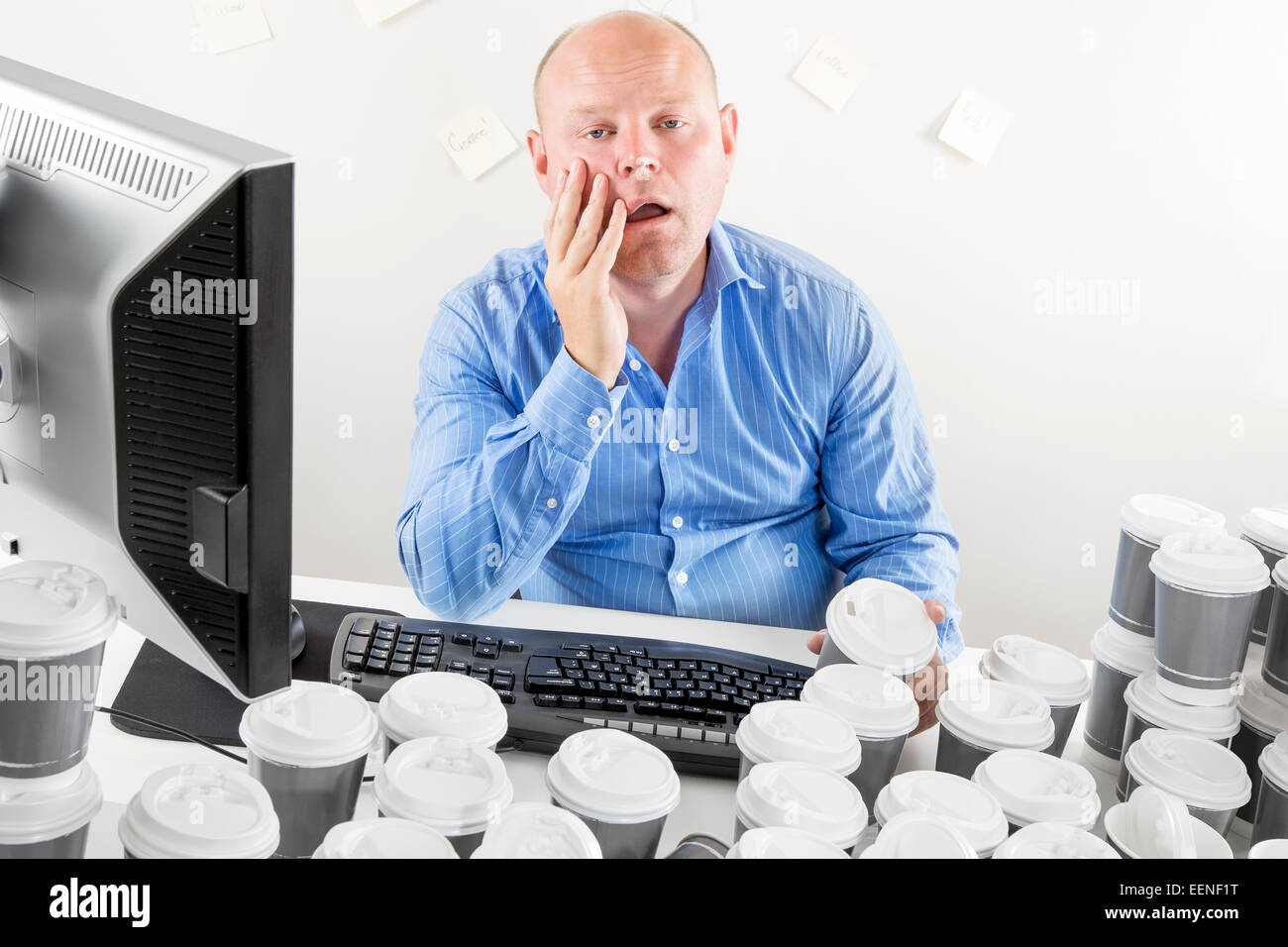 Overworked and exhausted businessman at the office Stock Photo - Alamy