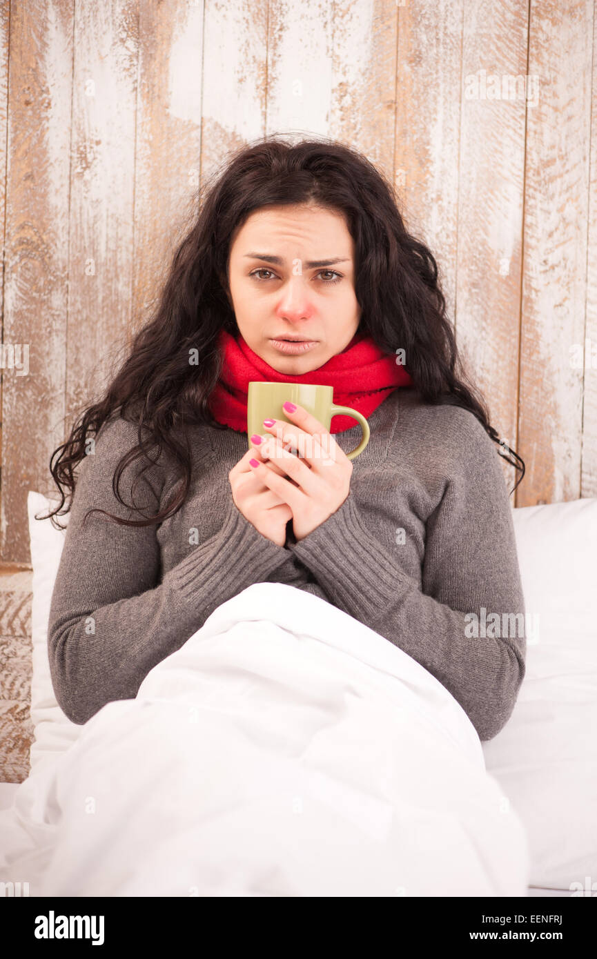 Frustrated sick girl with cup Stock Photo - Alamy