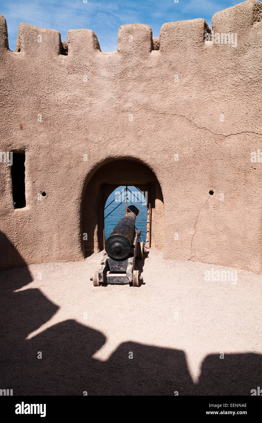 Cannon in historic watchtower at the entrance to Muscat harbour, Oman ...