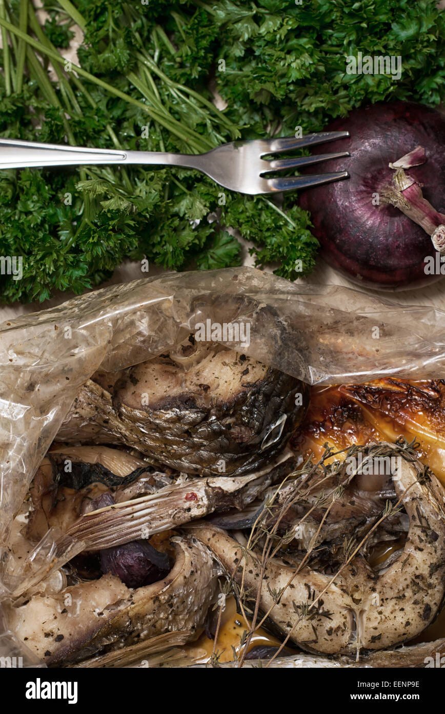 fragrant slices in greens with oven roasted fresh fish Stock Photo - Alamy