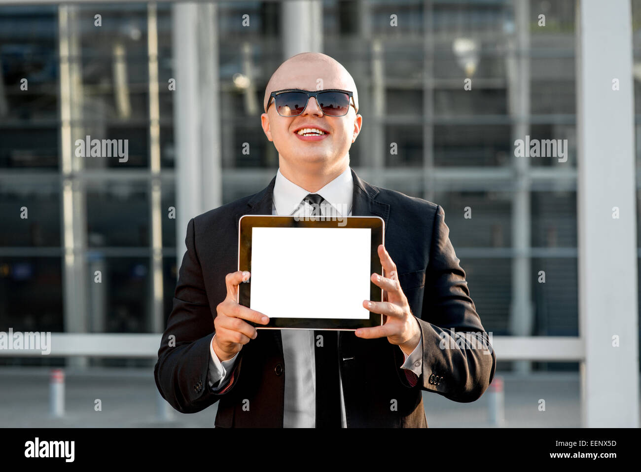 Businessman with nametable waiting for someone outside the airport or ...