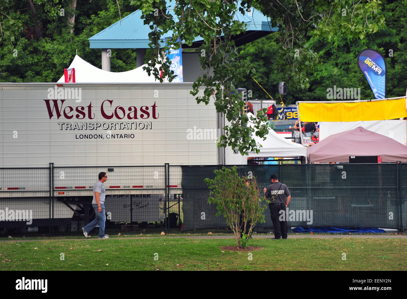 A security guard in front of a music festival perimeter fence Stock ...