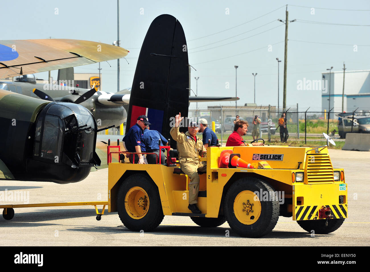 A tug pulling a world war two bomber Stock Photo - Alamy