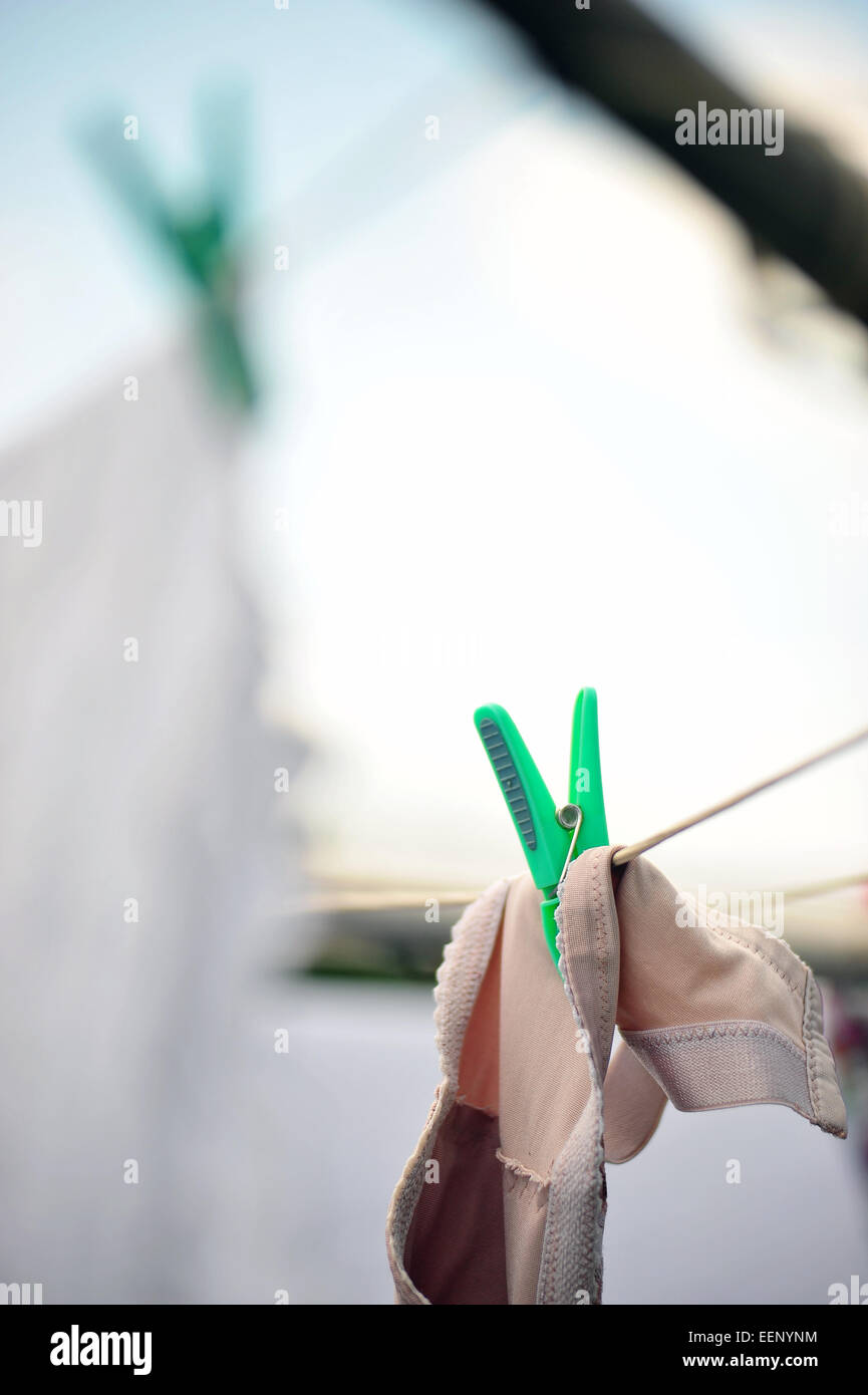 Clothes hanging on a washing line from clothes pegs Stock Photo - Alamy