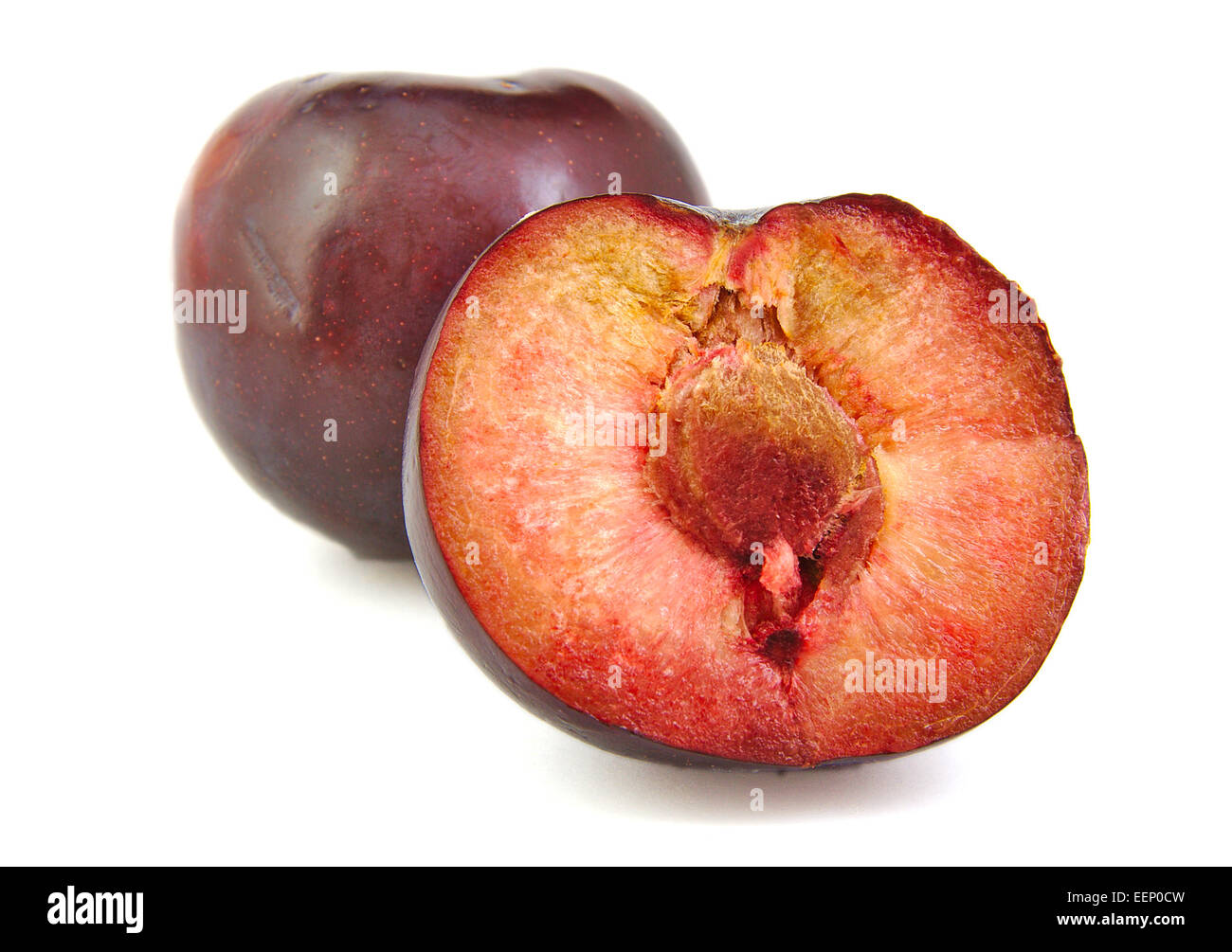 Plum and a half on white background Stock Photo - Alamy