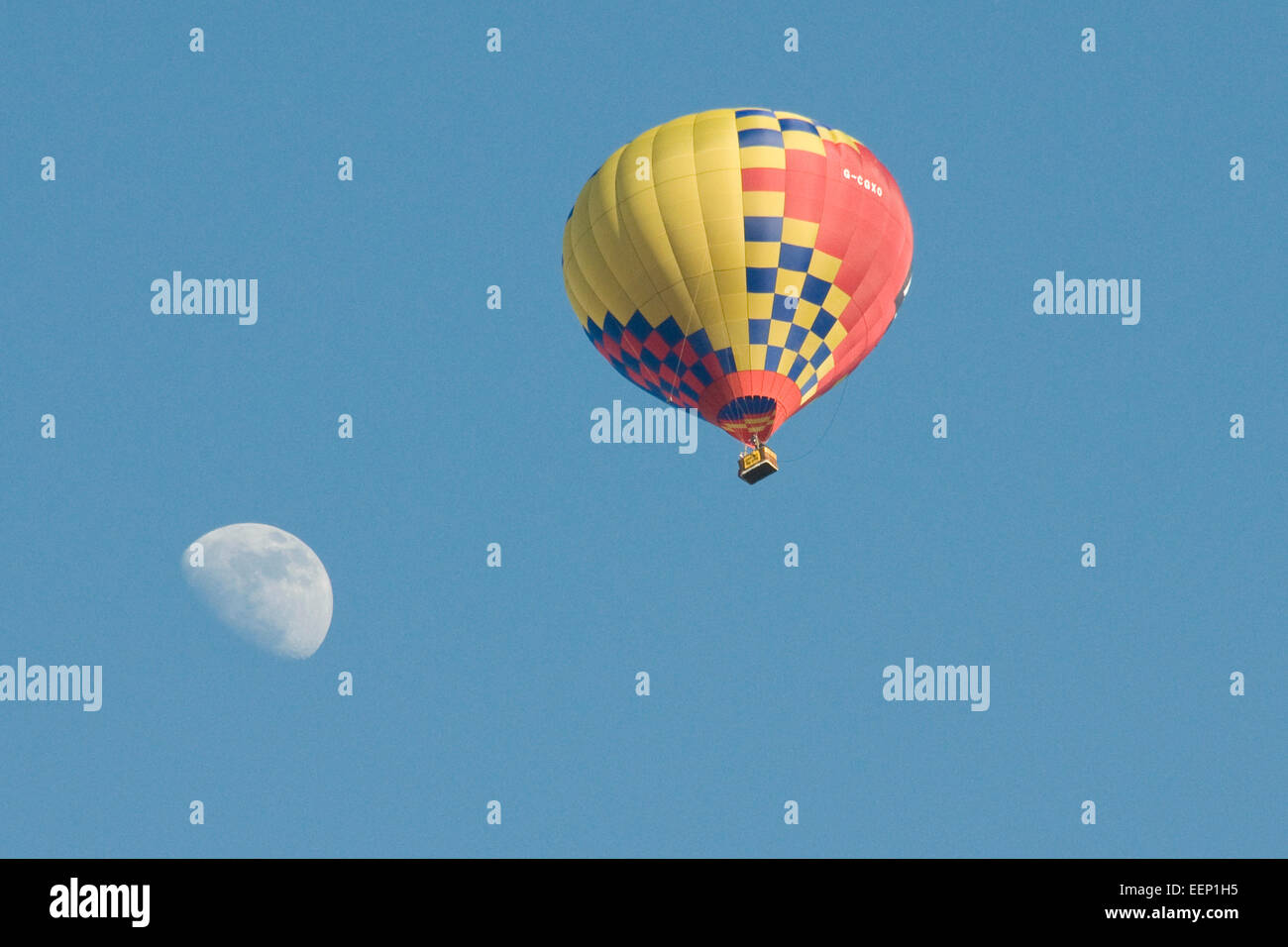 Hot air balloon over Devon, passing across the moon Stock Photo - Alamy