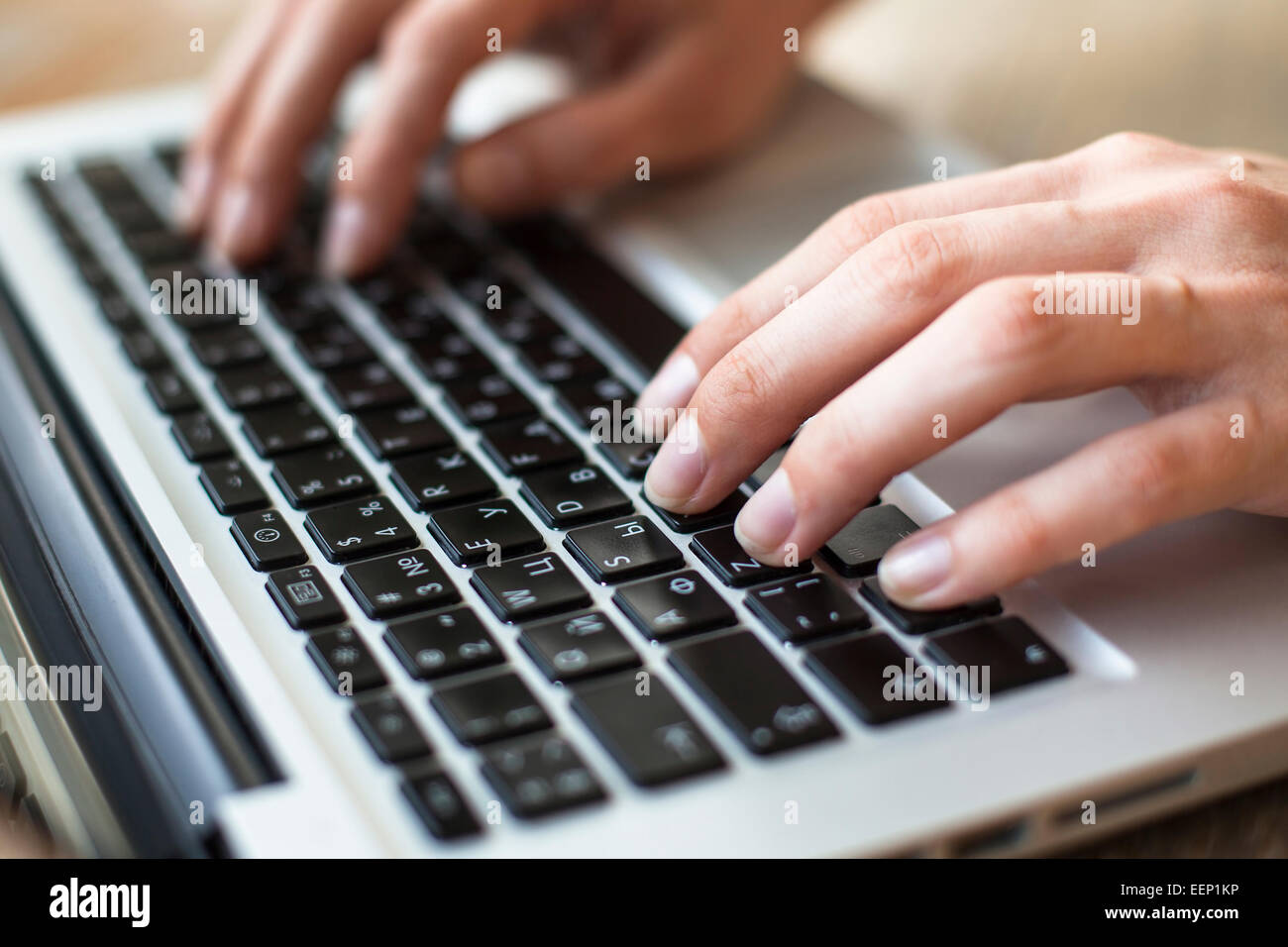 Women's fingers typing on laptop keyboard Stock Photo - Alamy